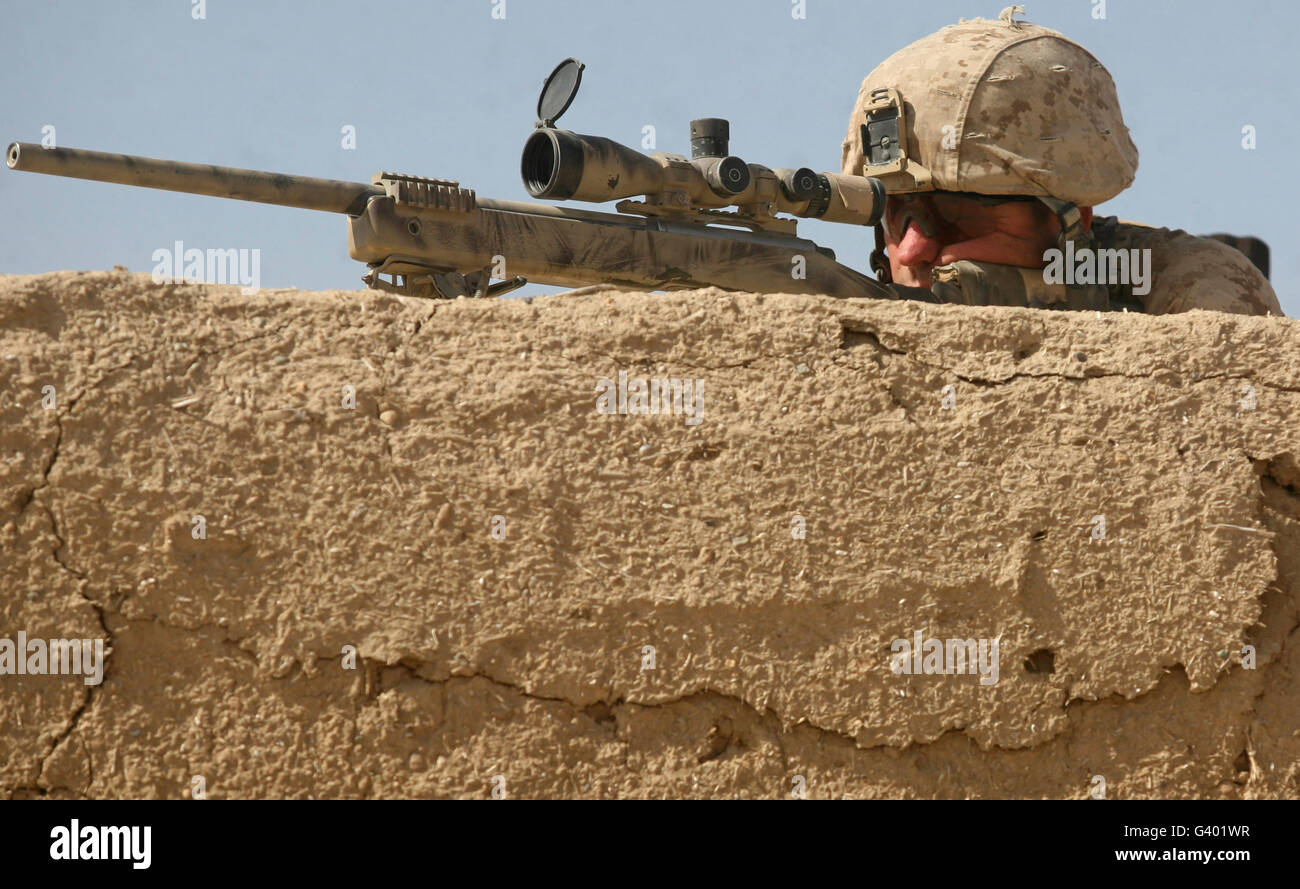 A scout sniper provides security inside a compound in Marjah ...