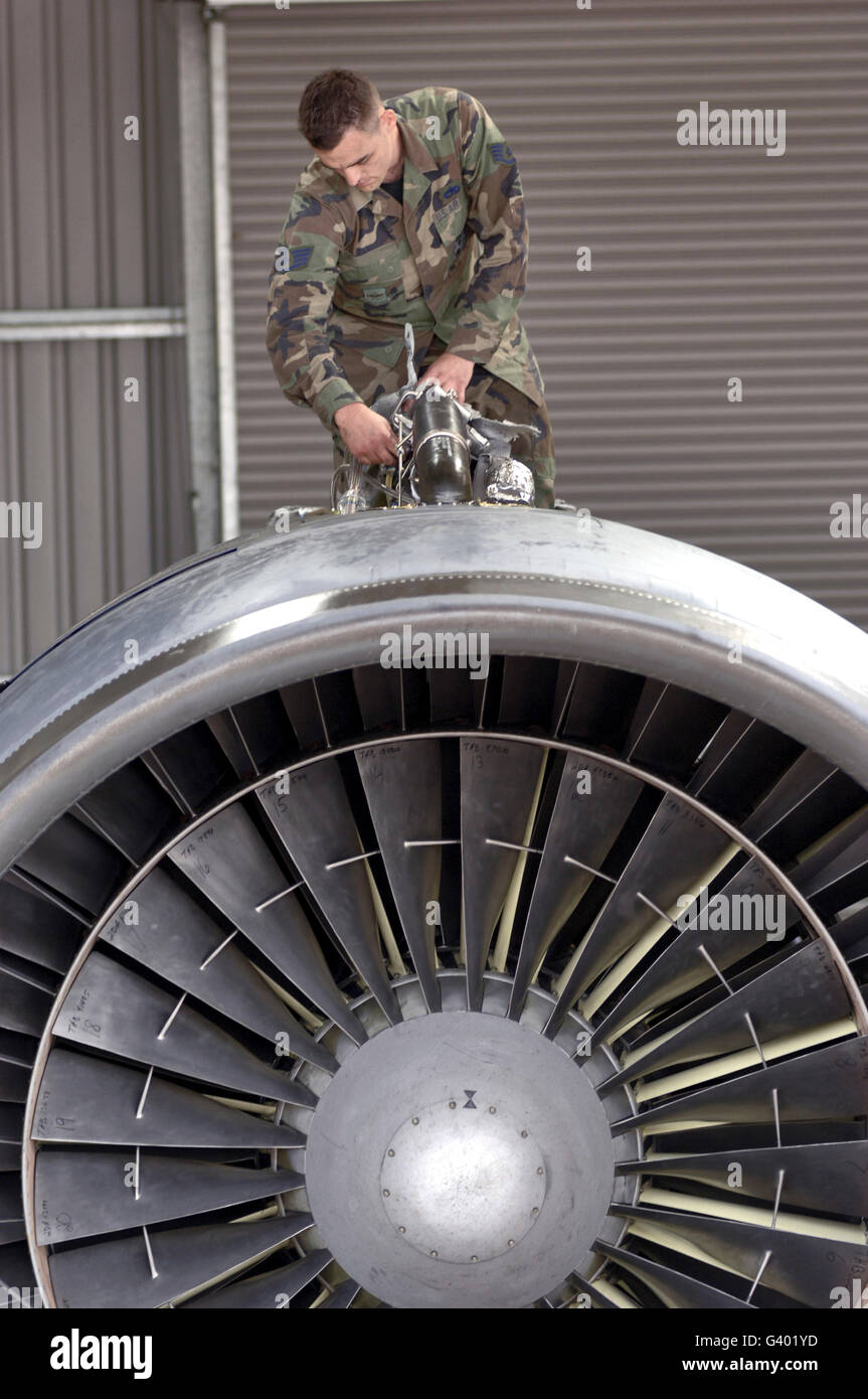 Airman checks components atop a C-5 Galaxy turbofan engine Stock Photo ...
