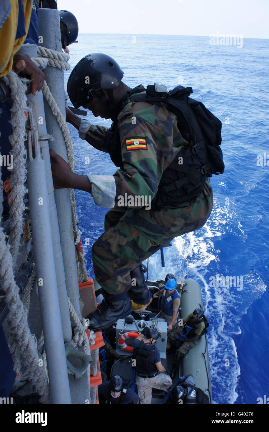 A marine from the Uganda Peopleâ€™s Defense Force descends a U.S. Navy ...