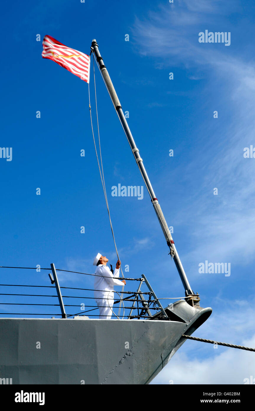 A sailor lowers the U.S. Navy Jack aboard USS Chafee Stock Photo - Alamy