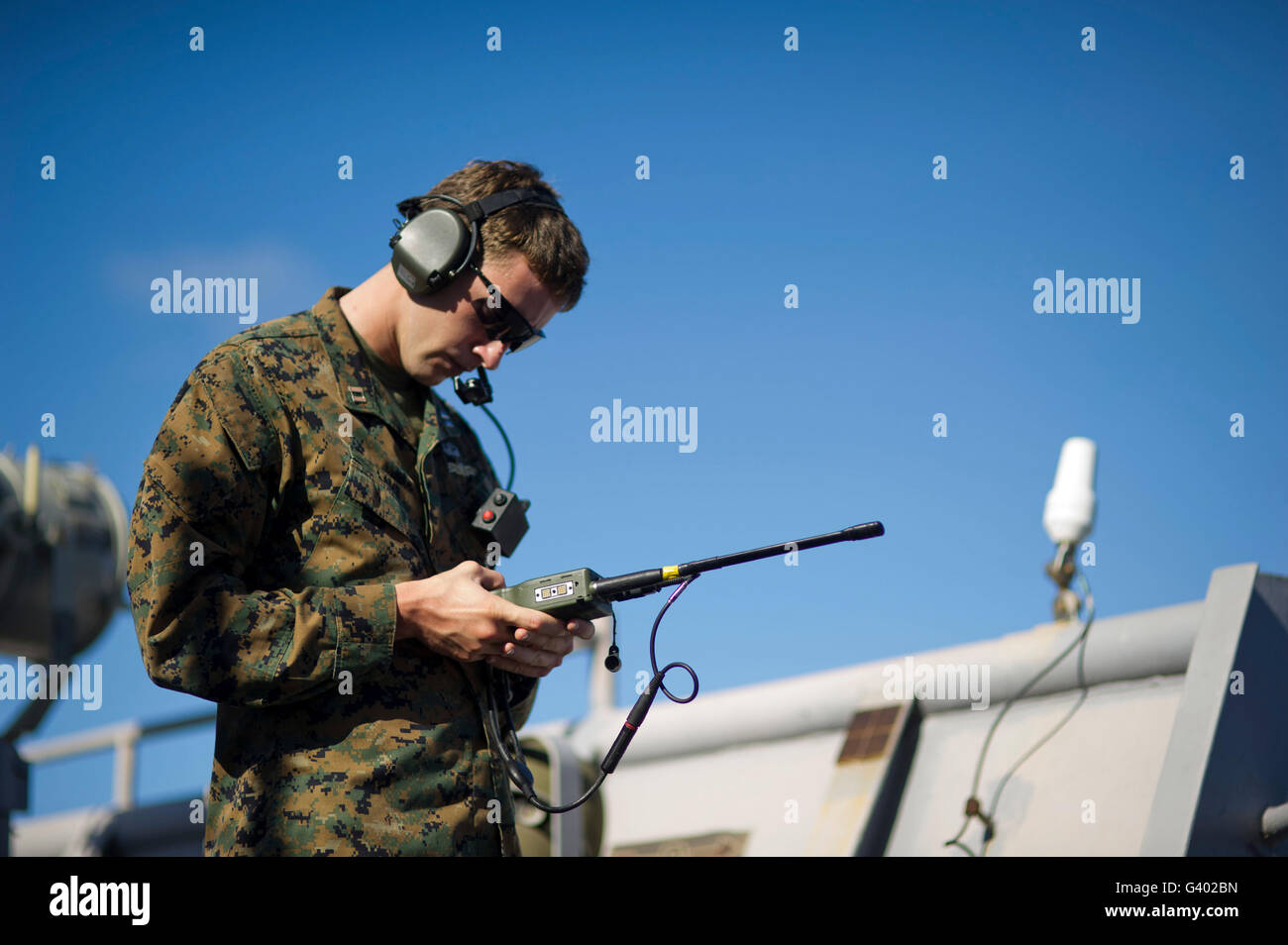 Soldier conducts a communications check aboard USS Pearl Harbor Stock ...