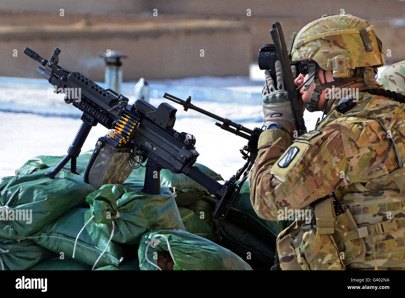 A soldier keeps a close watch from the roof of a district center in ...
