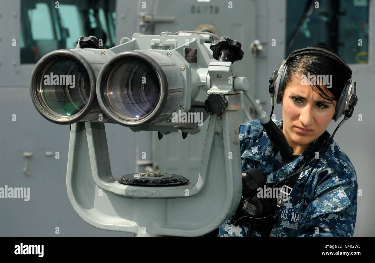 Operations Specialist looks out from the port bridge wing aboard USS ...
