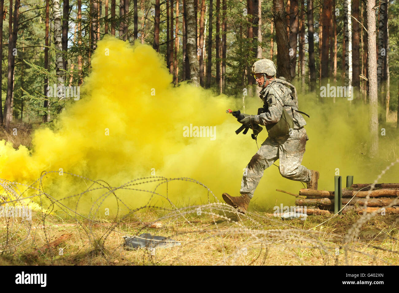 People running through obstacle course hi-res stock photography and ...
