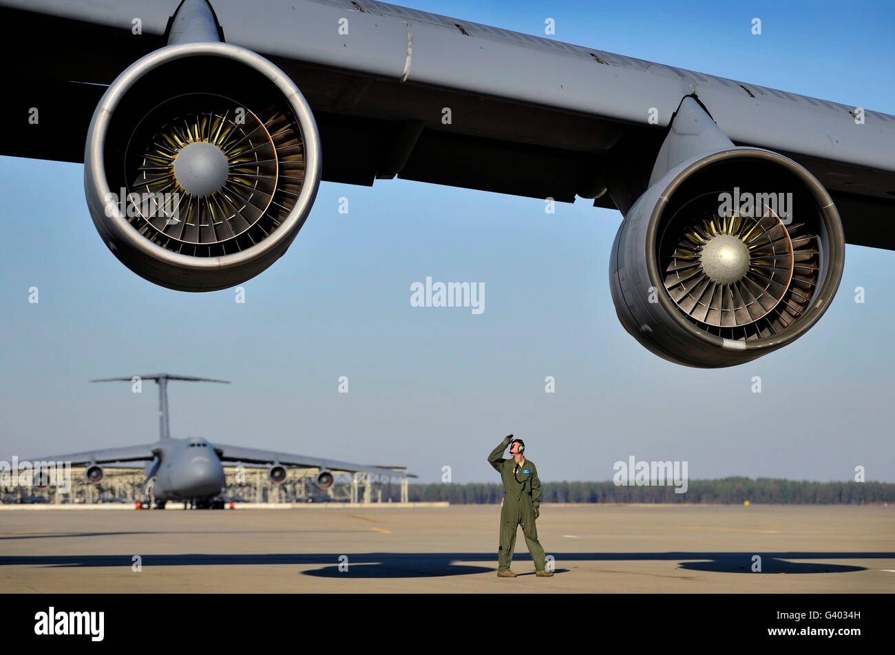 U.S. Air Force crew chief performs a post-flight inspection on a C-5 ...