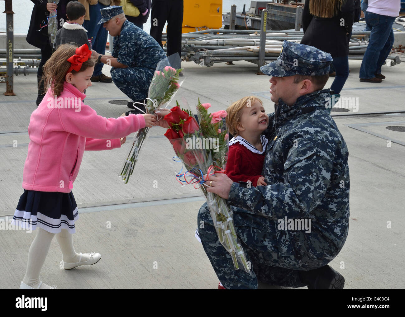 U.S. Navy sailors are greeted by their families during homecoming Stock ...