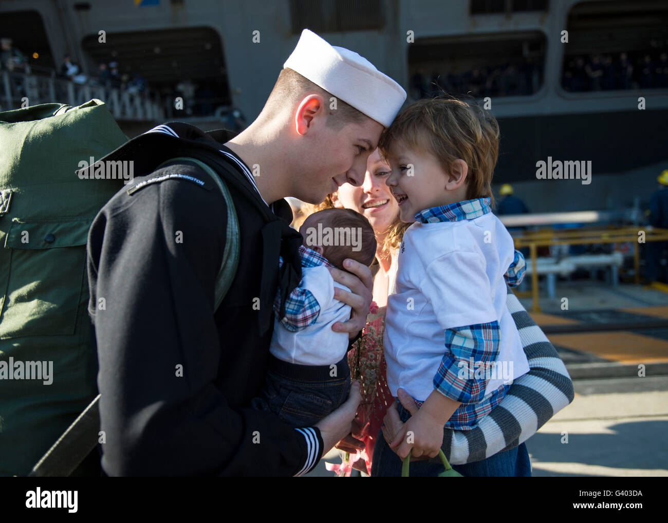 U.S. Navy sailor greets his family on the pier at homecoming Stock ...