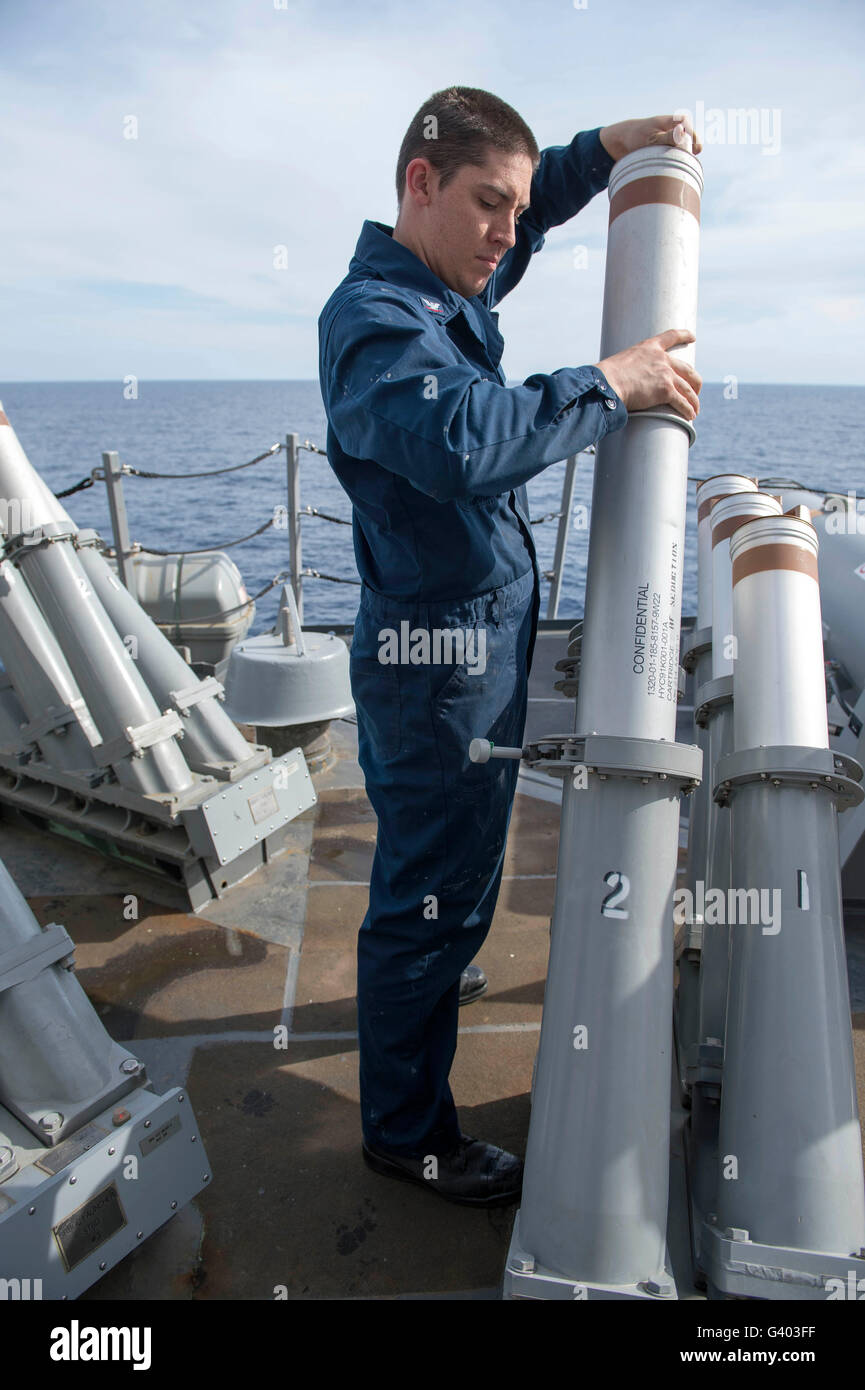 Cryptologic Technician loads an MK-214 seduction chaff canister into a ...