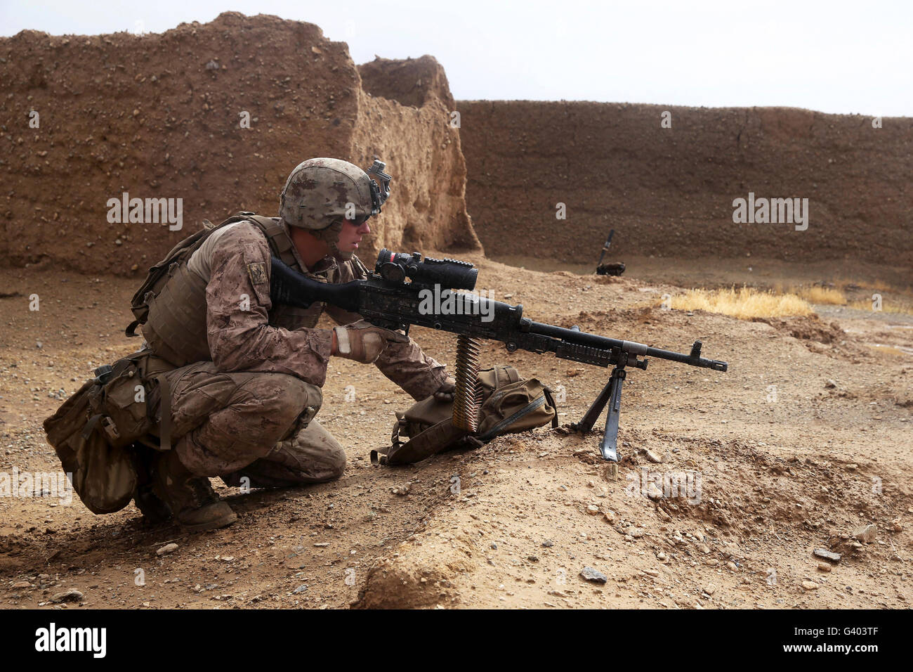 U.S. Marine gunner provides security with an M240B medium machine gun ...