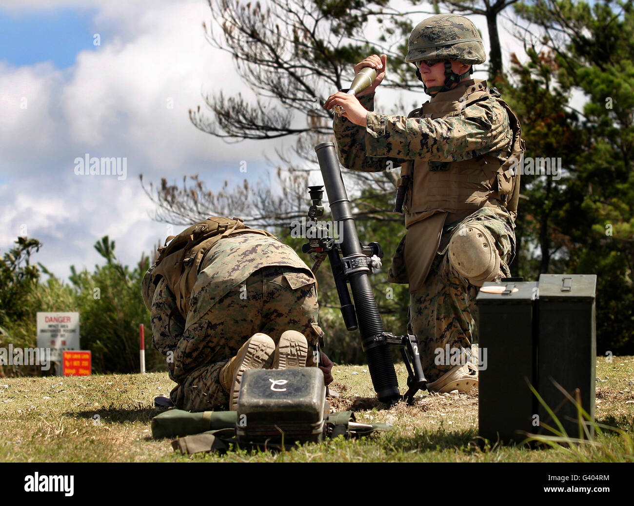 A soldier loads a high explosive mortar round into an M-224 60 mm lightweight mortar Stock Photo ...