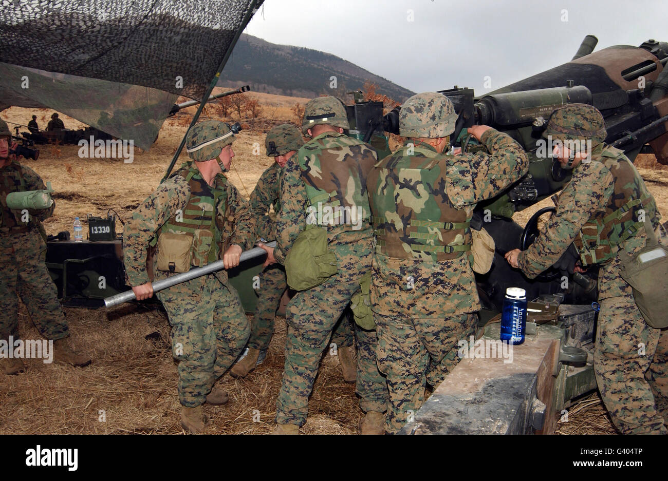 Marines load a 98-pound High Explosive round into a M198 howitzer Stock ...