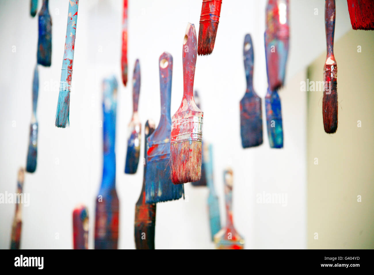 Colorful paint brushes hanging as artistic objects Stock Photo - Alamy