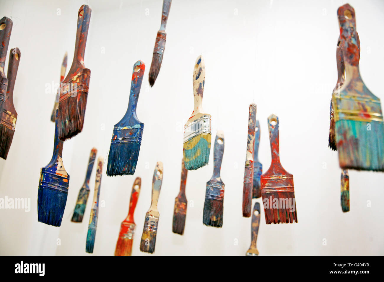 Colorful paint brushes hanging as artistic objects Stock Photo - Alamy