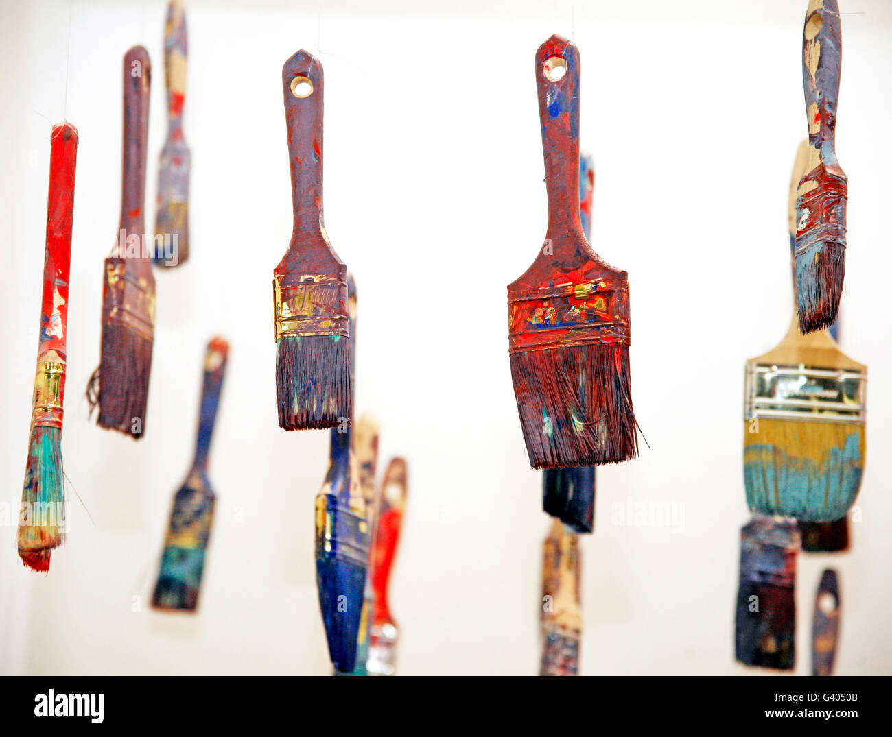 Art objects painty brushes hanging in the air Stock Photo - Alamy