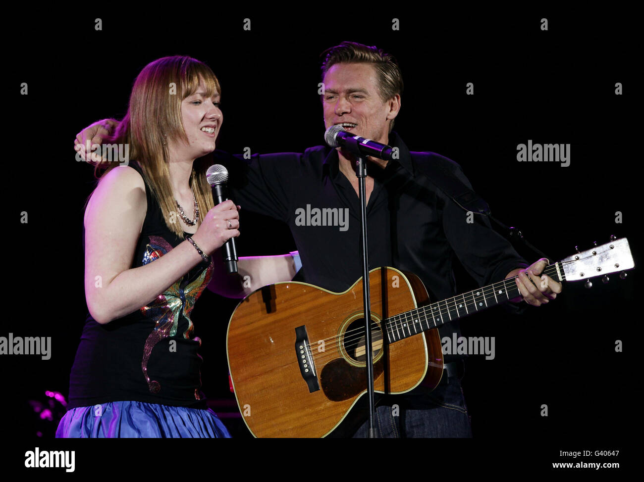 Bryan Adams performing with cancer survivor patient of the Killing ...
