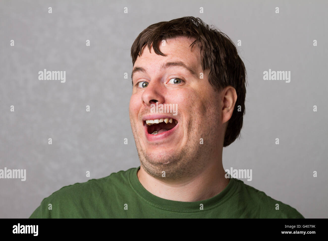 A guy smiling while looking at the camera. Smile is a little much ...