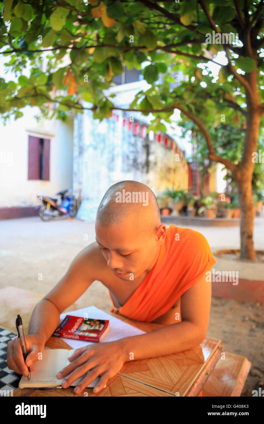 Laos Buddhist monk writing on a piece of paper Stock Photo - Alamy