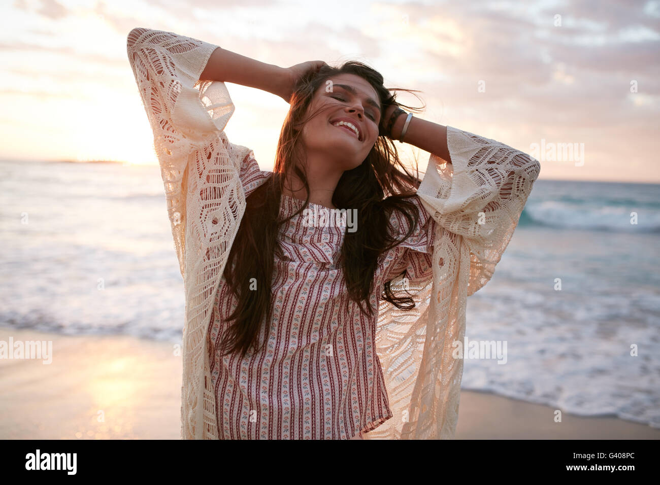Smiling Young Woman Enjoying Her Summer Vacation On The Beach