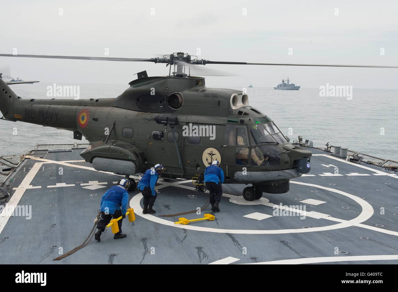A Romanian navy IAR-330 medium helicopter lands aboard the U.S. Navy ...