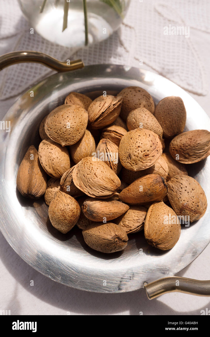 Whole Almonds shell in a plate Stock Photo - Alamy
