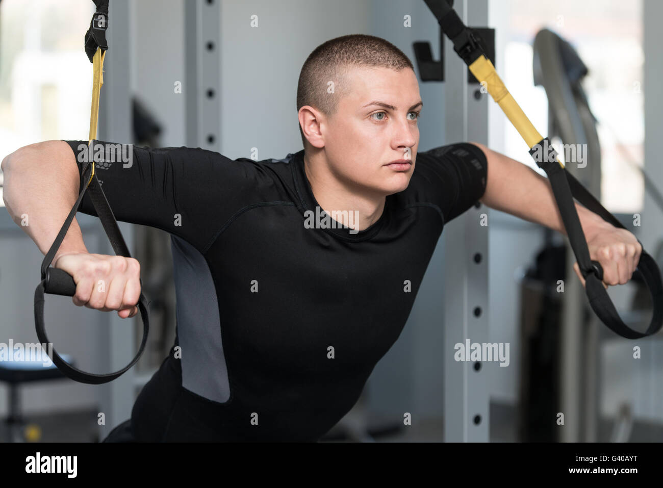 Attractive Young Man Does Crossfit Push Ups With Trx Fitness Straps In ...