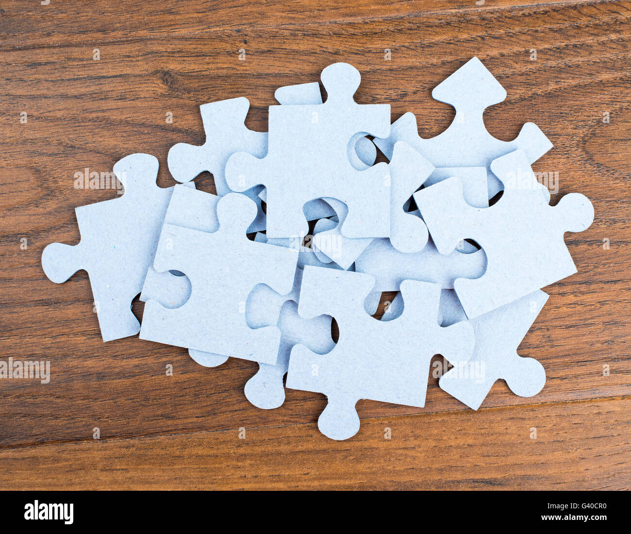 Pile of puzzle pieces on table Stock Photo - Alamy