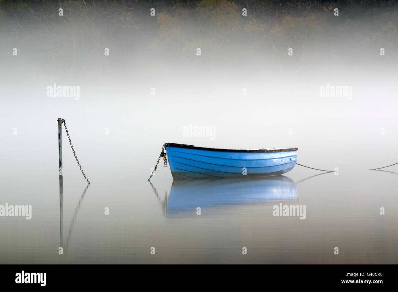 Rowing Boat on misty lake Stock Photo - Alamy