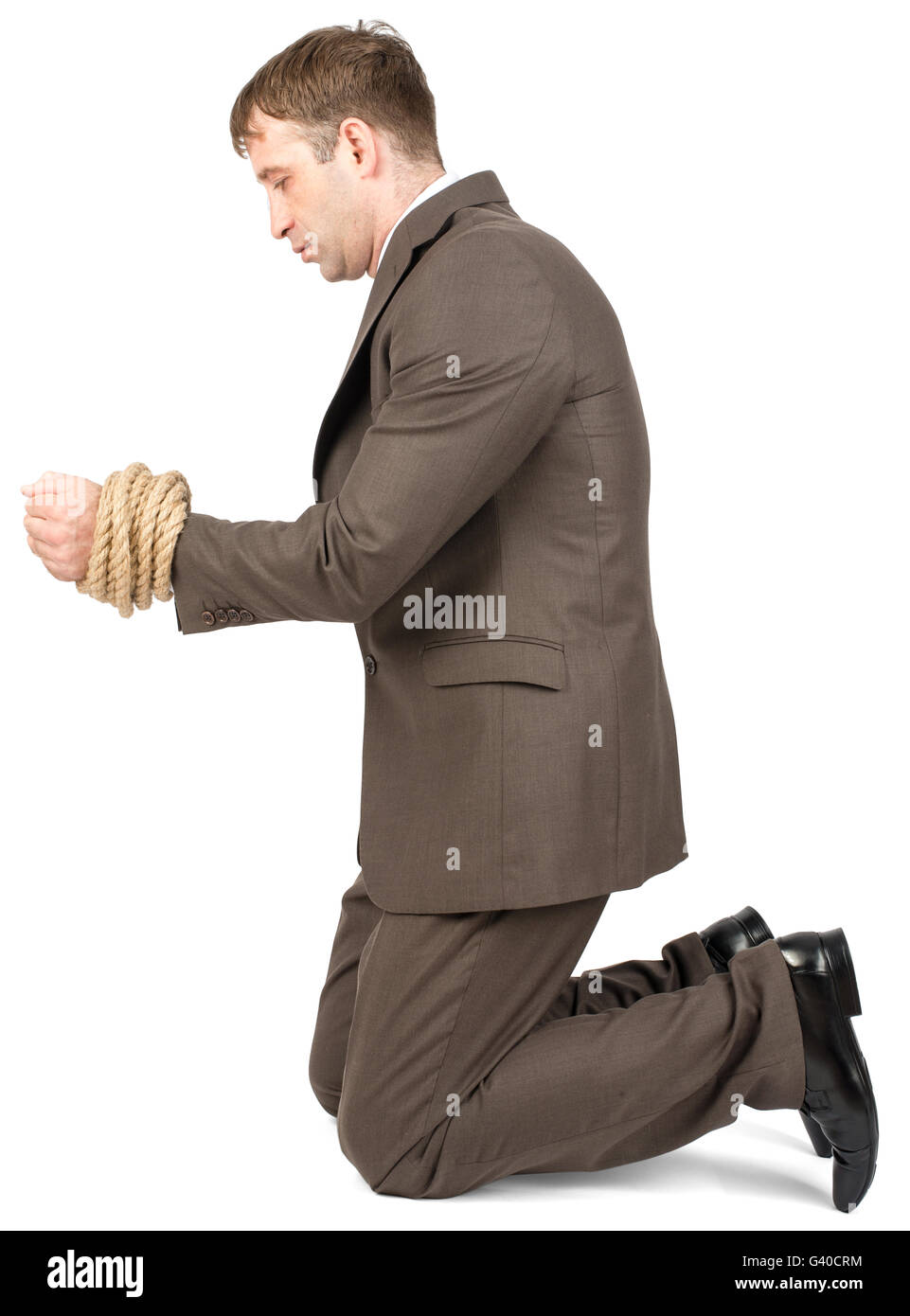 Young man kneeling Stock Photo - Alamy