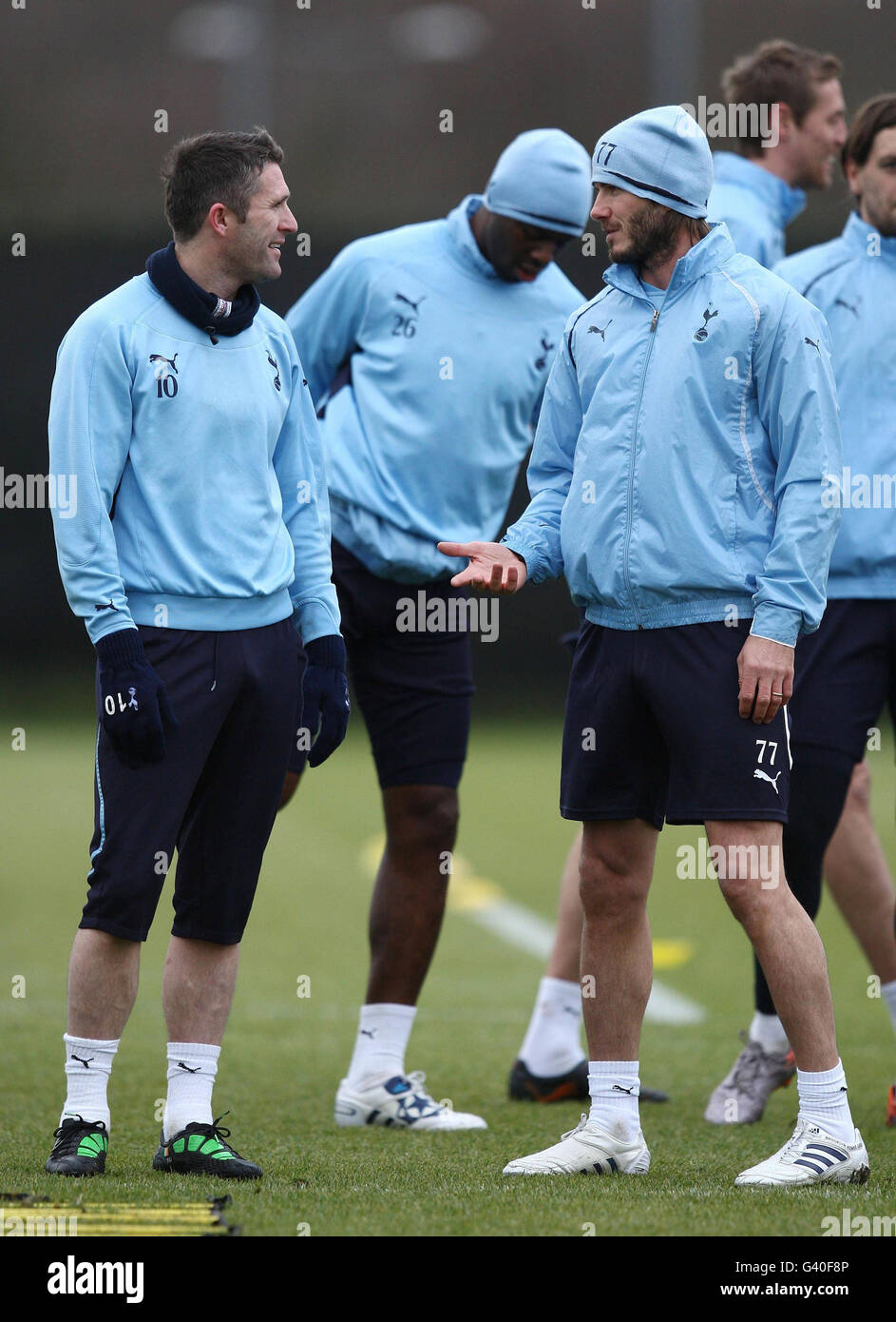 David Beckham speaks with Tottenham's Robbie Keane (left) during a ...