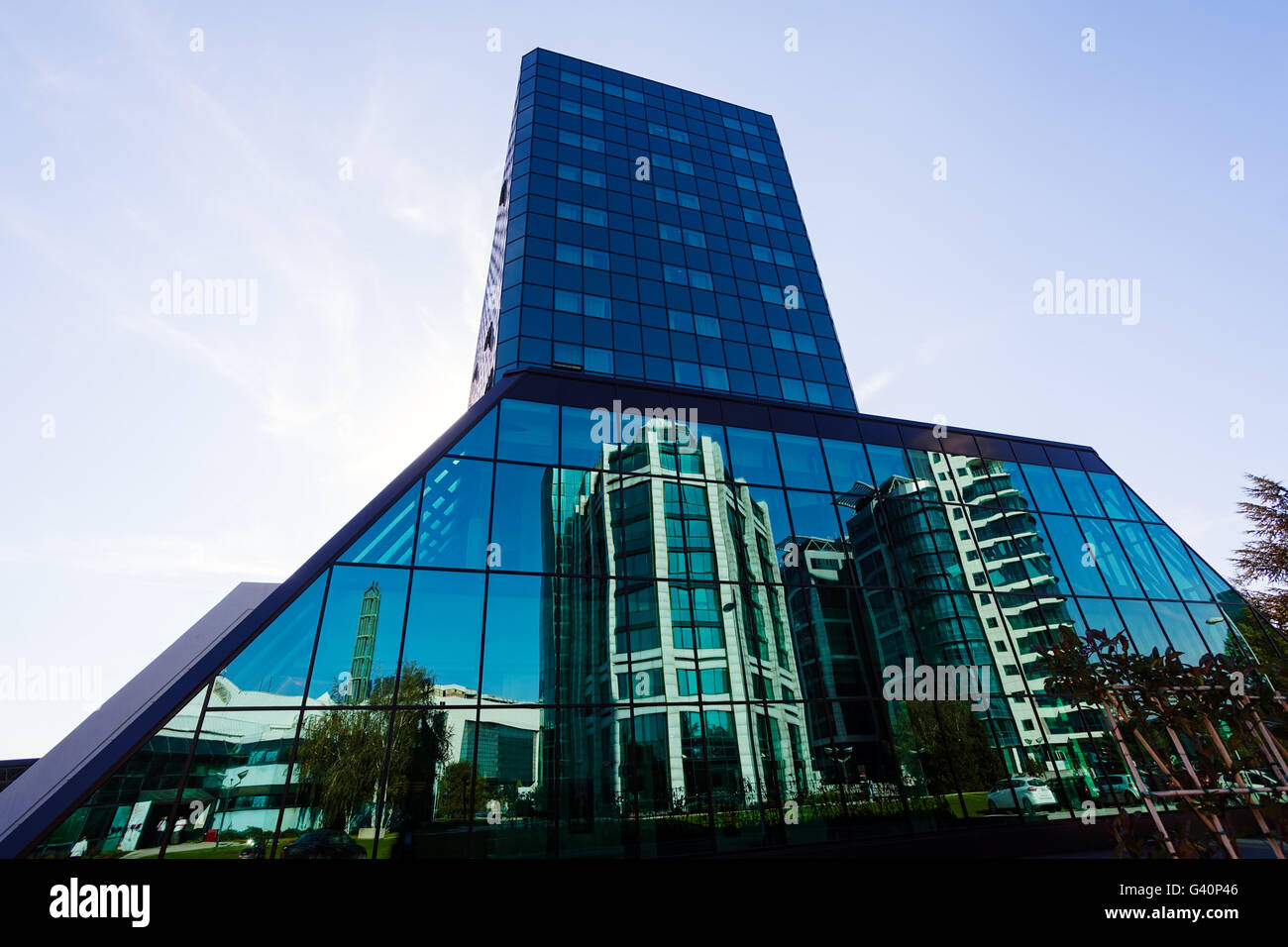 Reflections on modern building's blue and green glass facade Stock ...