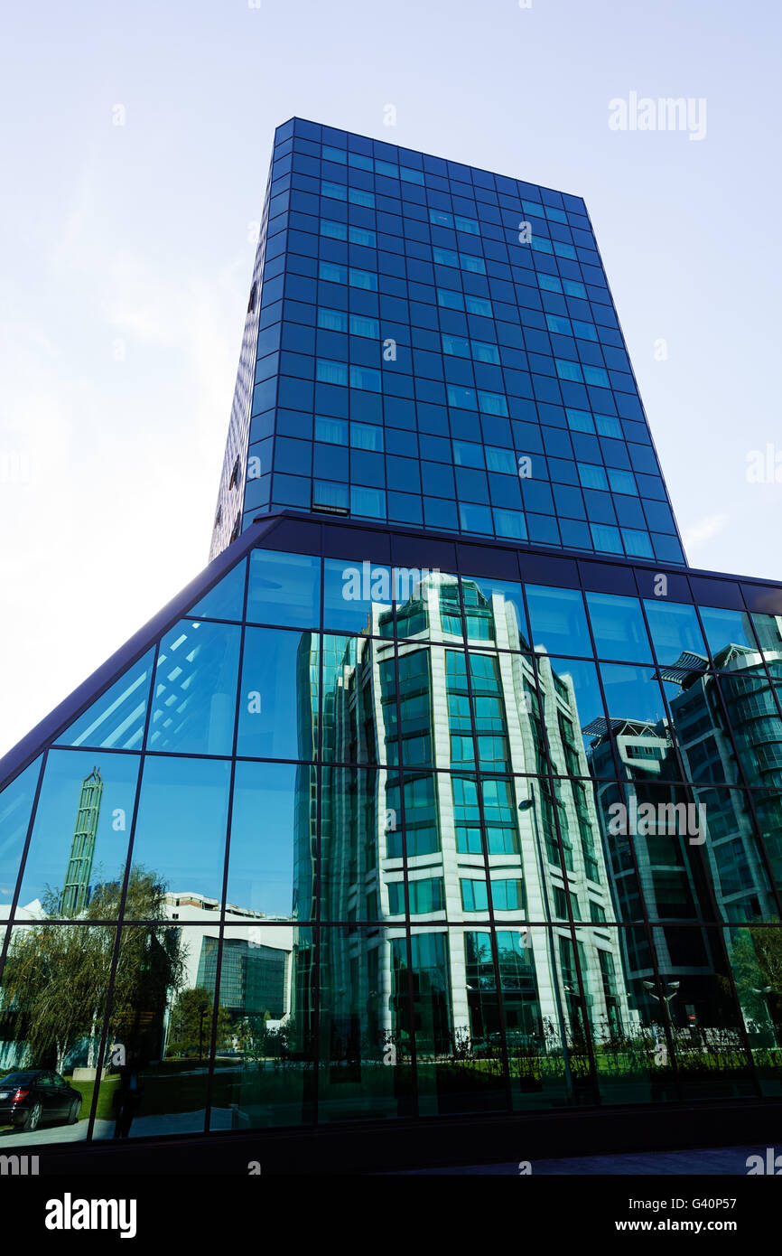 Reflections on modern building's blue and green glass facade Stock ...