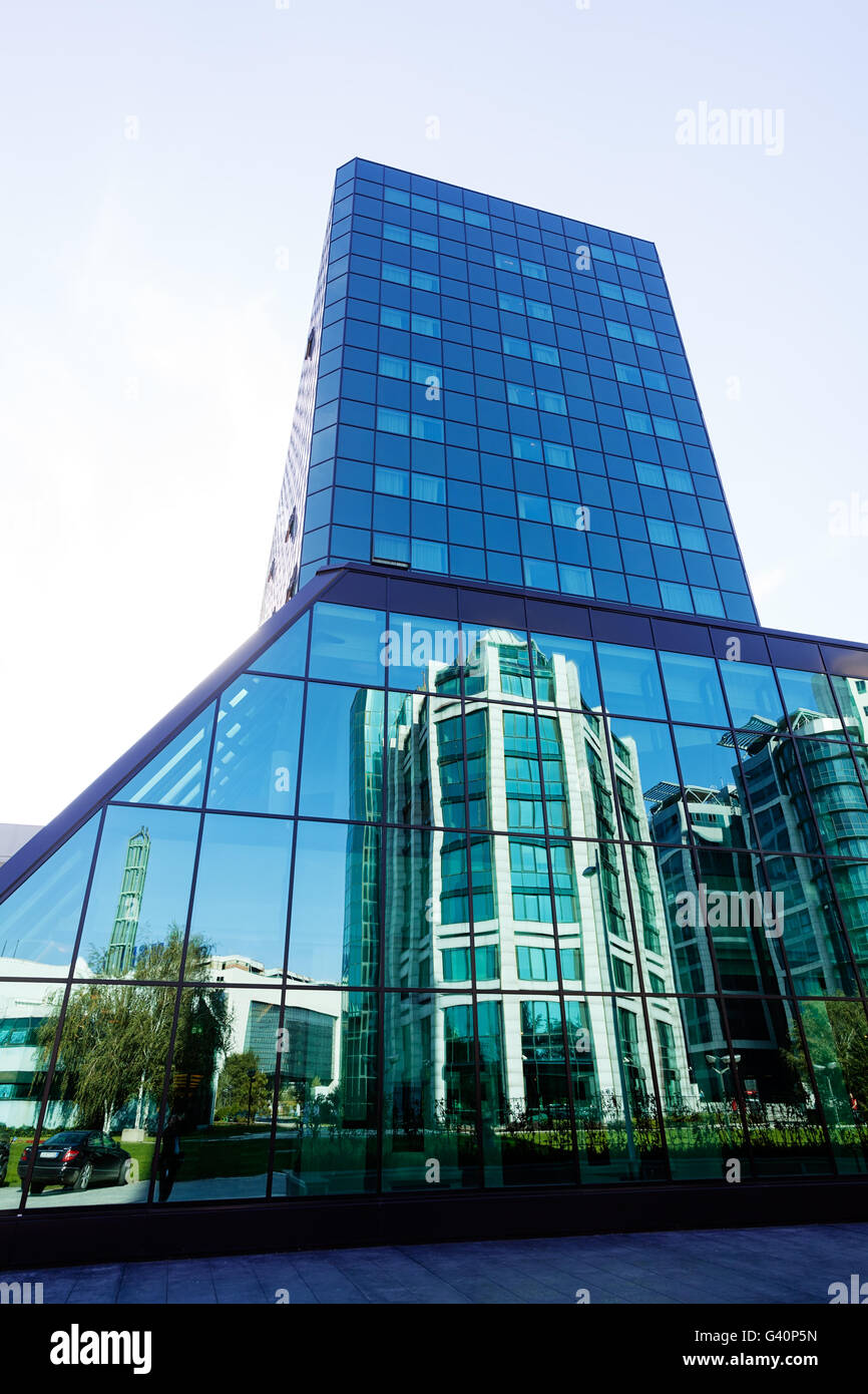 Reflections on modern building's blue and green glass facade Stock ...