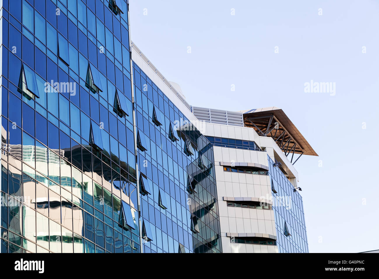 Reflections on modern building's blue and green glass facade Stock ...