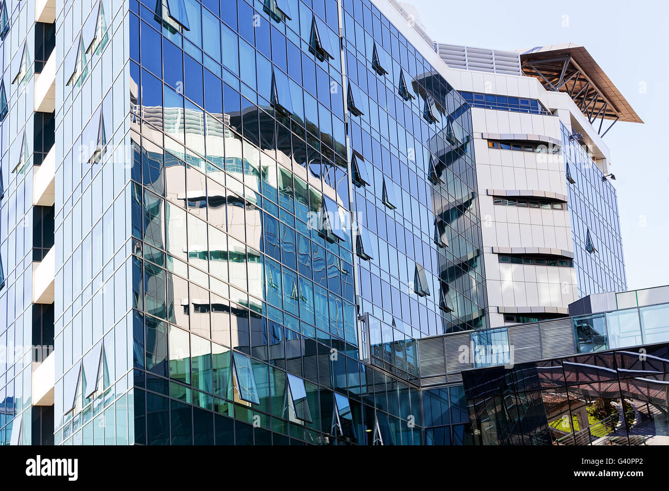 Reflections on modern building's blue and green glass facade Stock ...