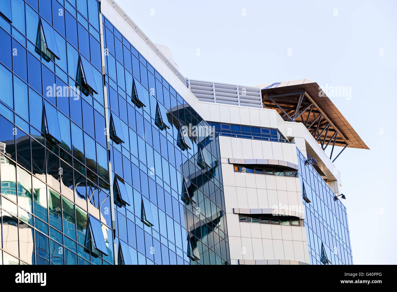Reflections on modern building's blue and green glass facade Stock ...