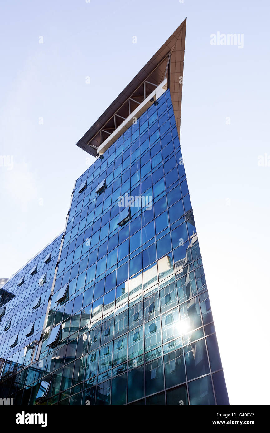 Reflections on modern building's blue and green glass facade Stock ...