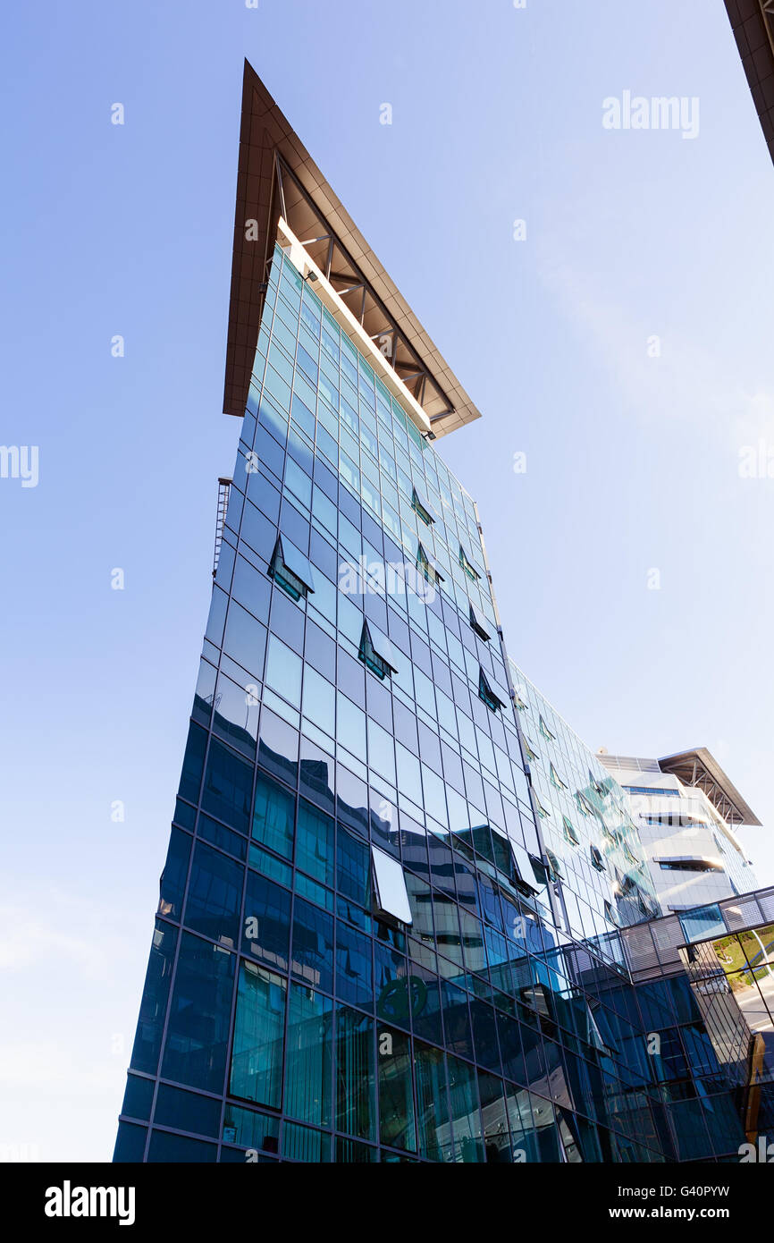 Reflections on modern building's blue and green glass facade Stock ...
