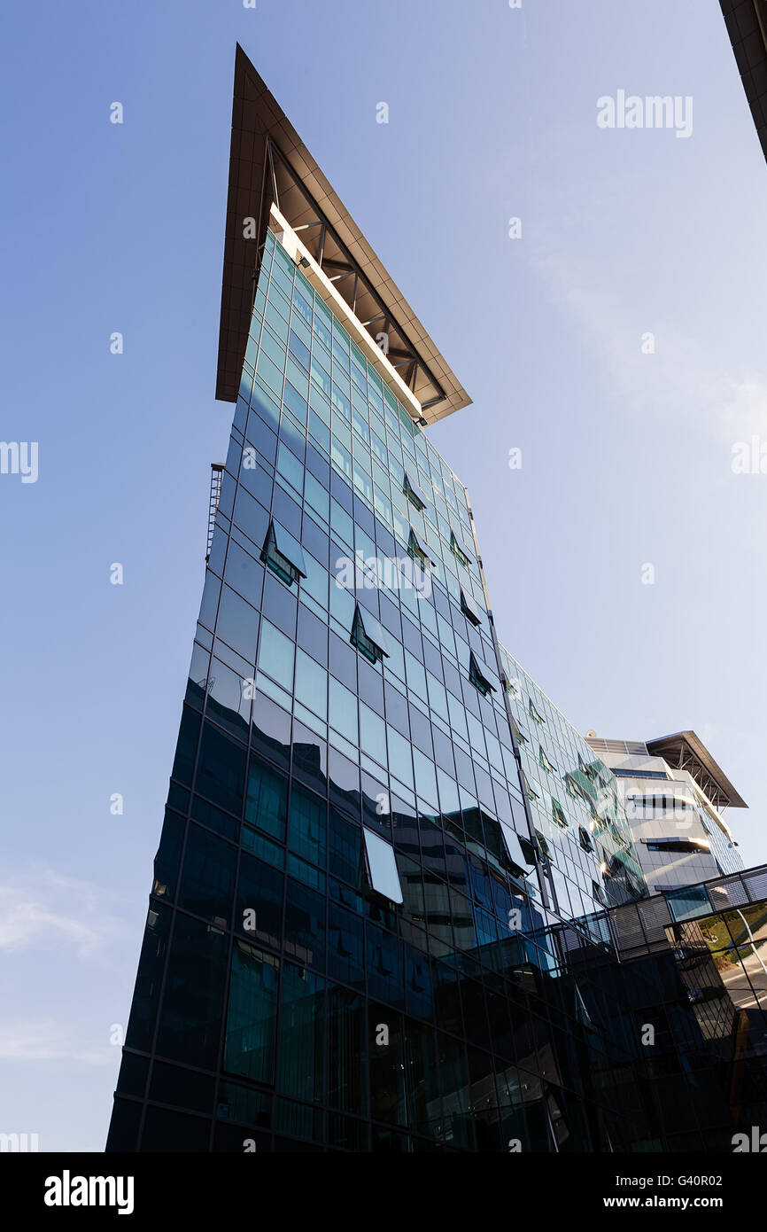 Reflections on modern building's blue and green glass facade Stock ...