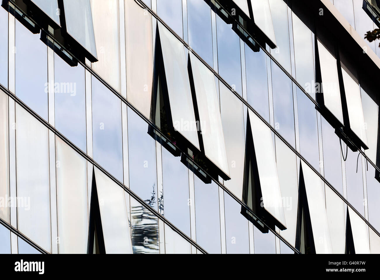 glass facade with opened windows on a modern building Stock Photo - Alamy
