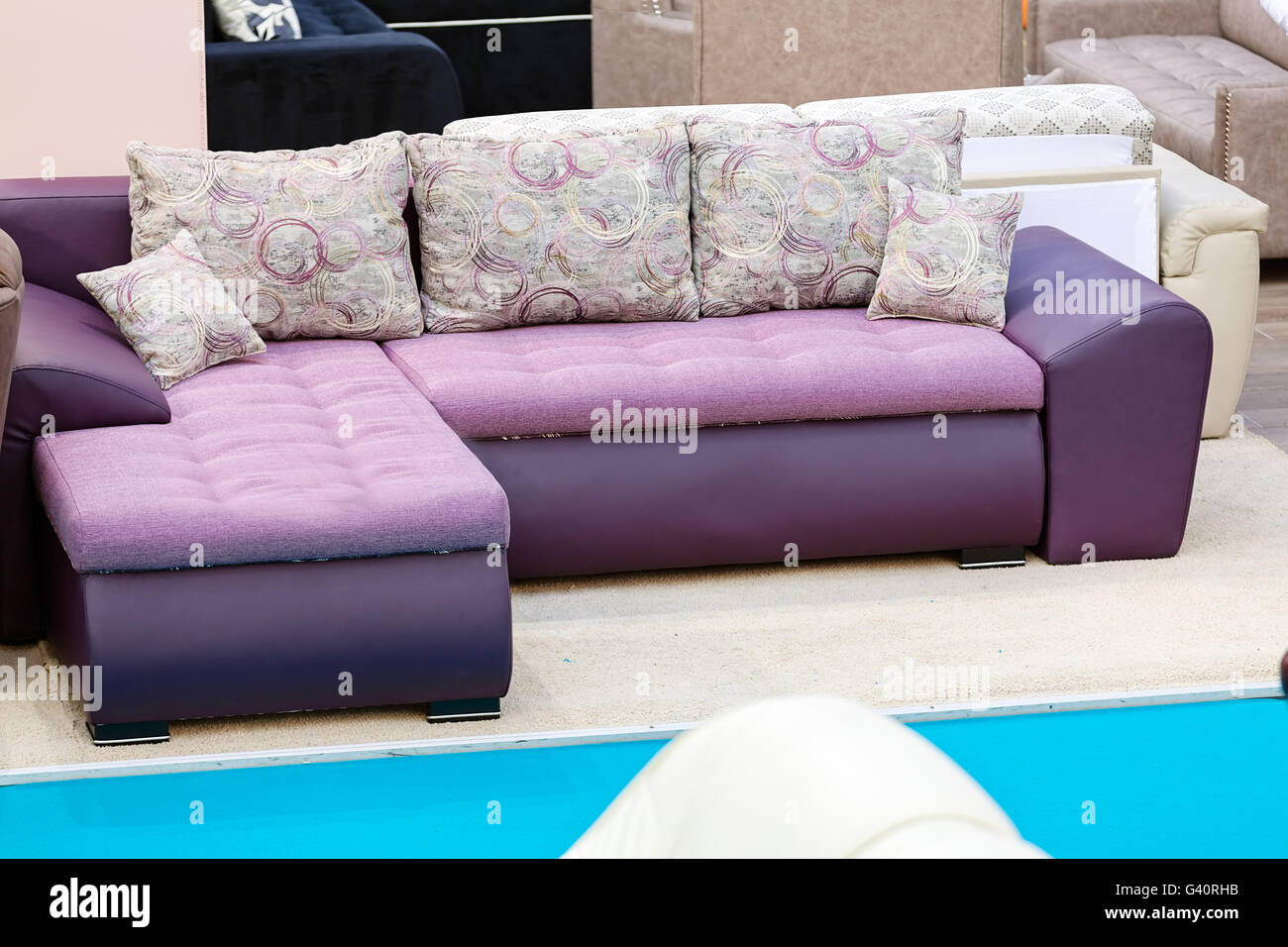 comfort purple corner couch with spottily pillows Stock Photo - Alamy