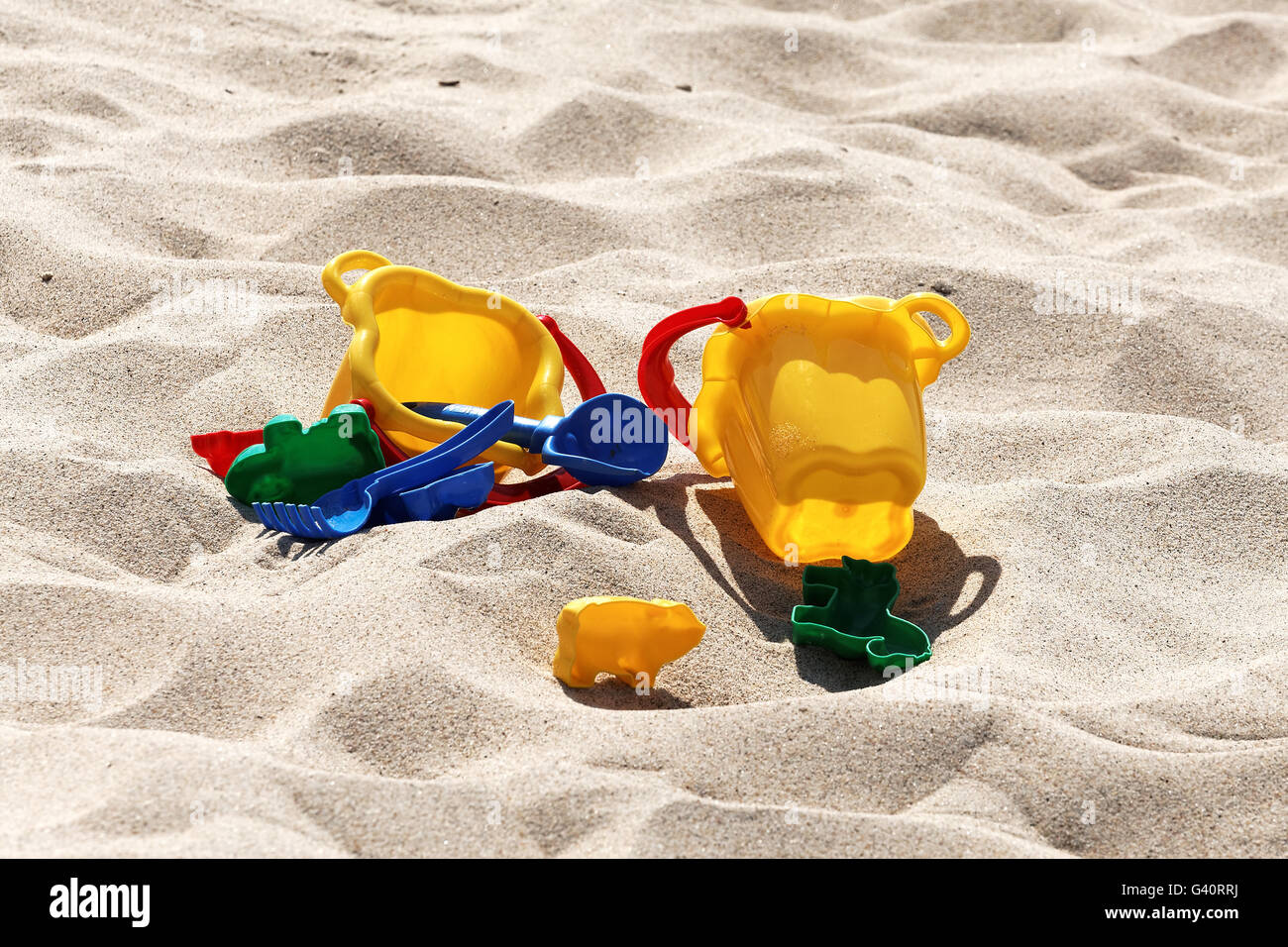 Plastic colored toys in the sand hi-res stock photography and images ...