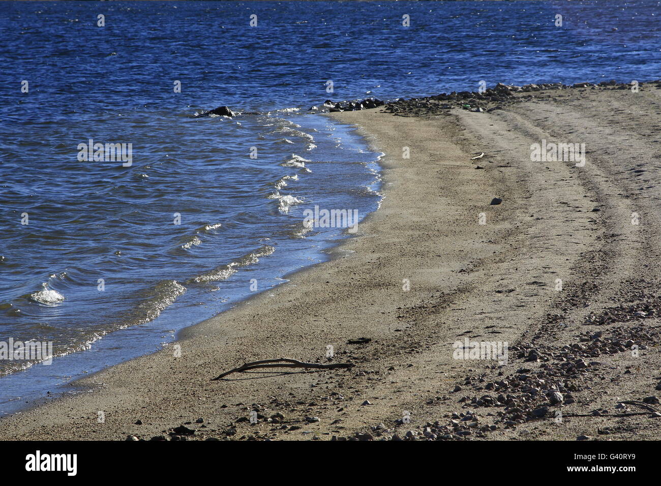 sandy shore with calm sea Stock Photo - Alamy