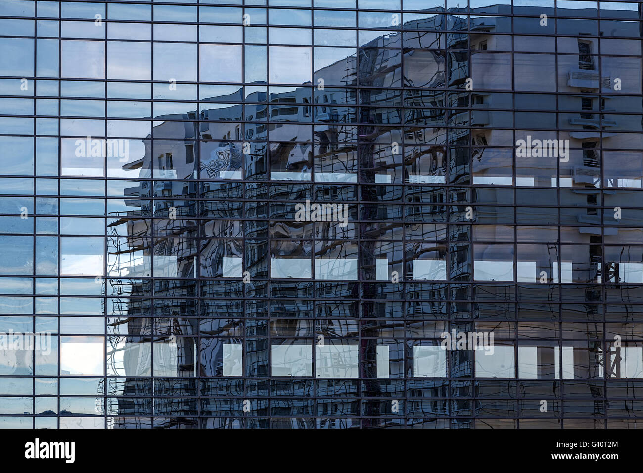 reflection of stone facade on modern glass facade Stock Photo - Alamy