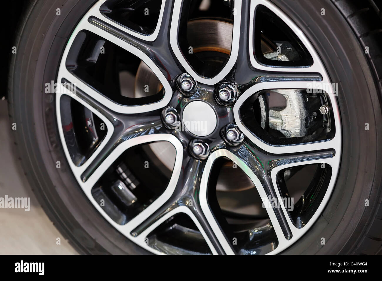 Modern steel car wheel with new tyre Stock Photo - Alamy