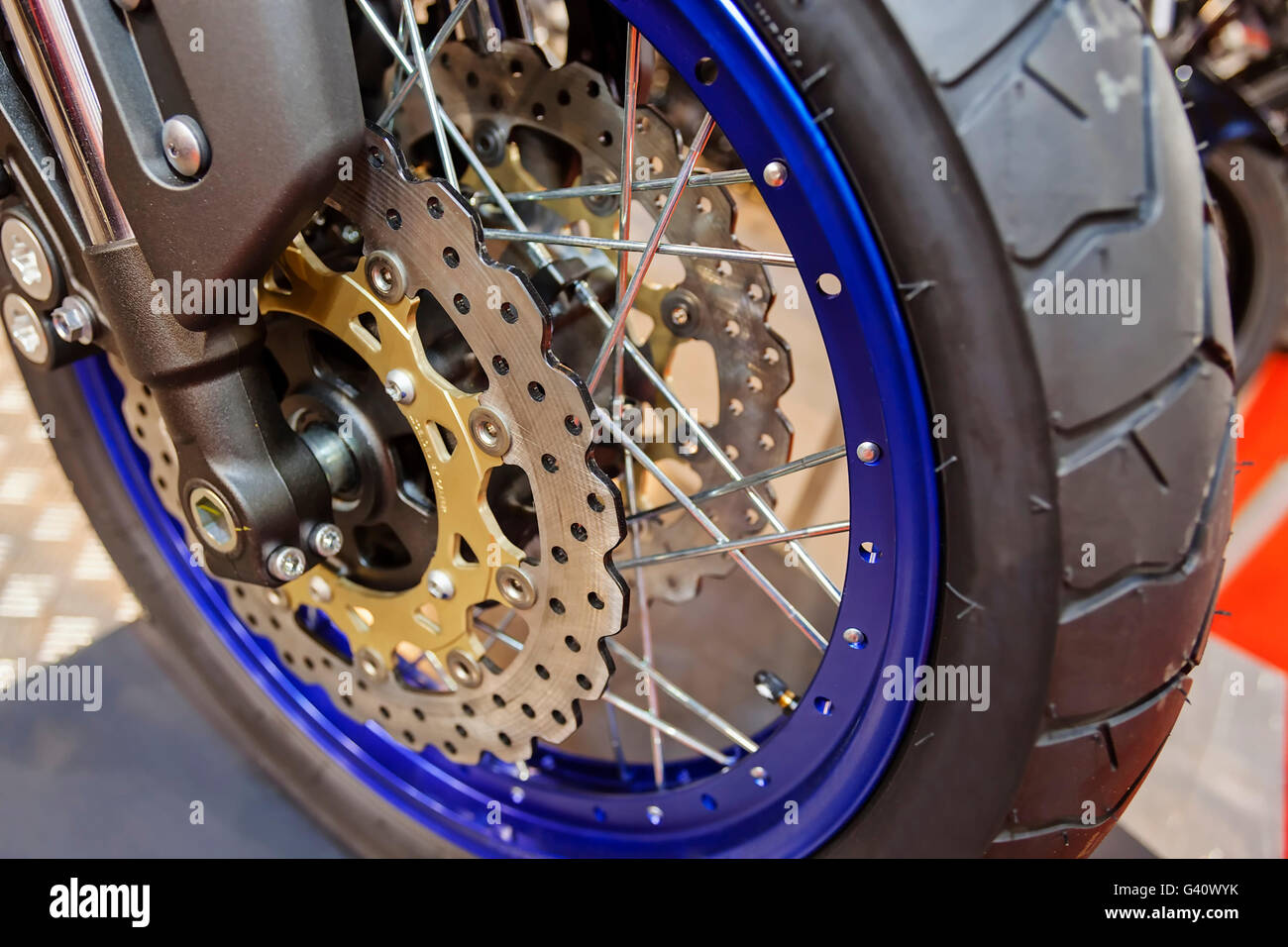 Closeup of quality steel motorcycle wheel with new tyre; note shallow ...