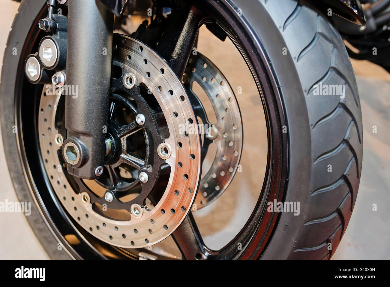 Closeup of quality steel motorcycle wheel with new tyre; note shallow ...