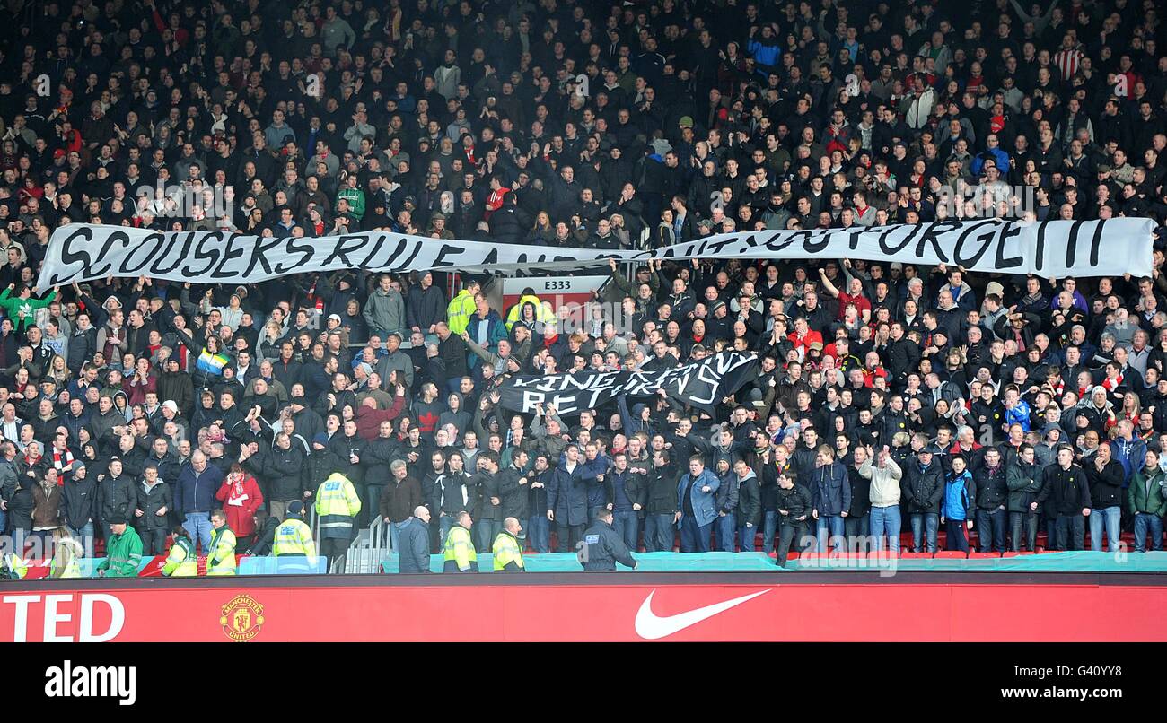 Manchester united fans with a banner in the stands hi-res stock ...