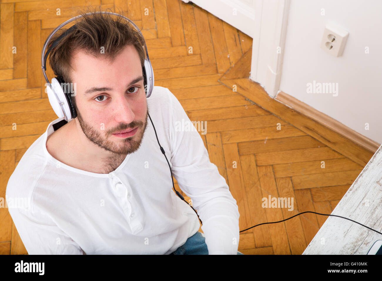 A young man listening to music on his Laptop computer Stock Photo - Alamy