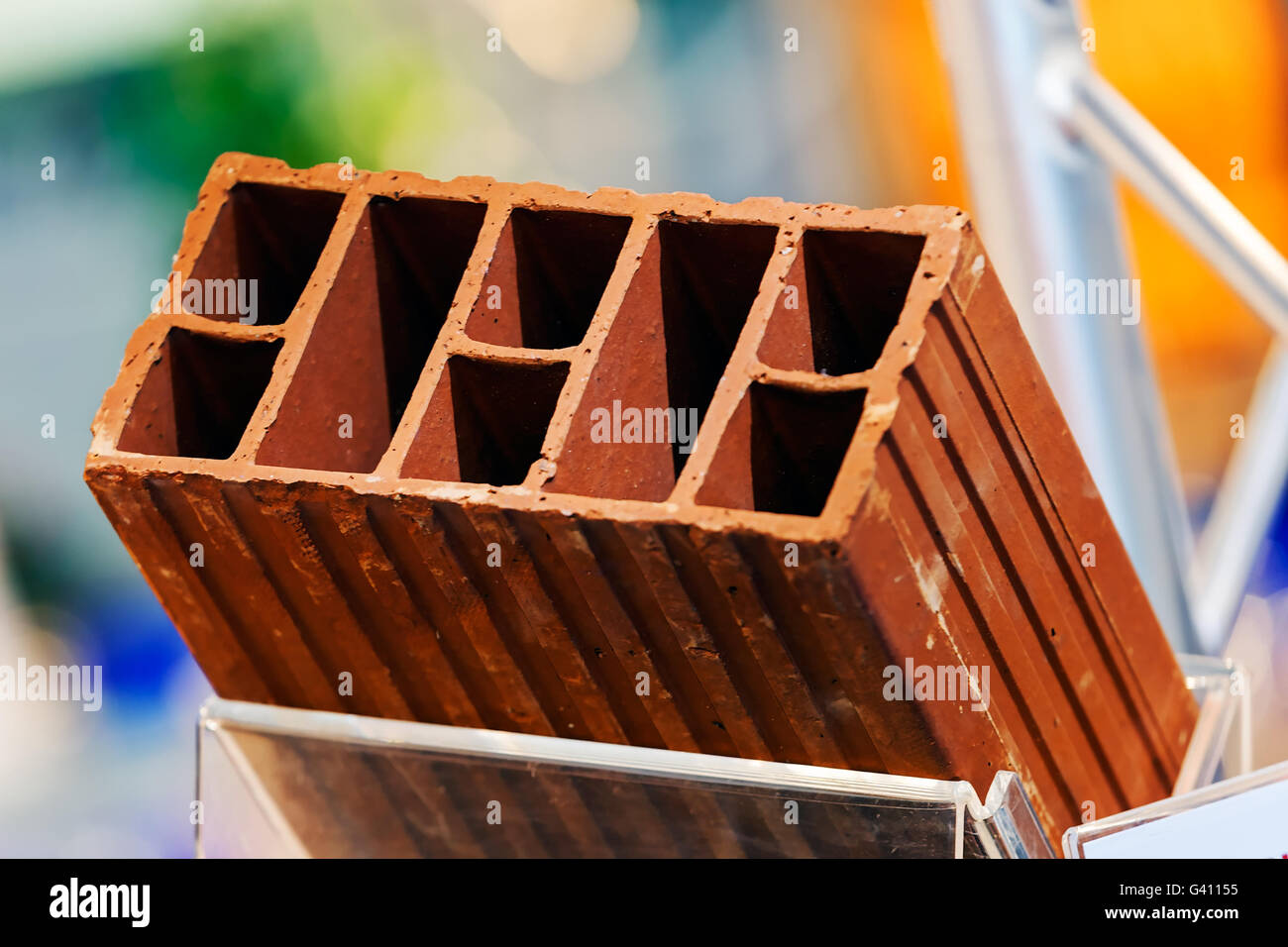 Detail of orange hollow clay block on a stand at construction fair ...