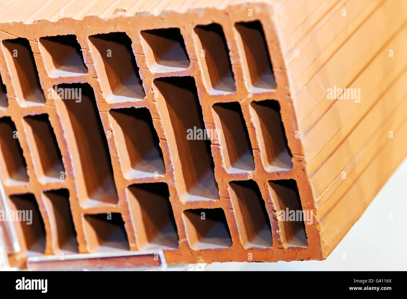 Detail of orange hollow clay block on a stand at construction fair ...